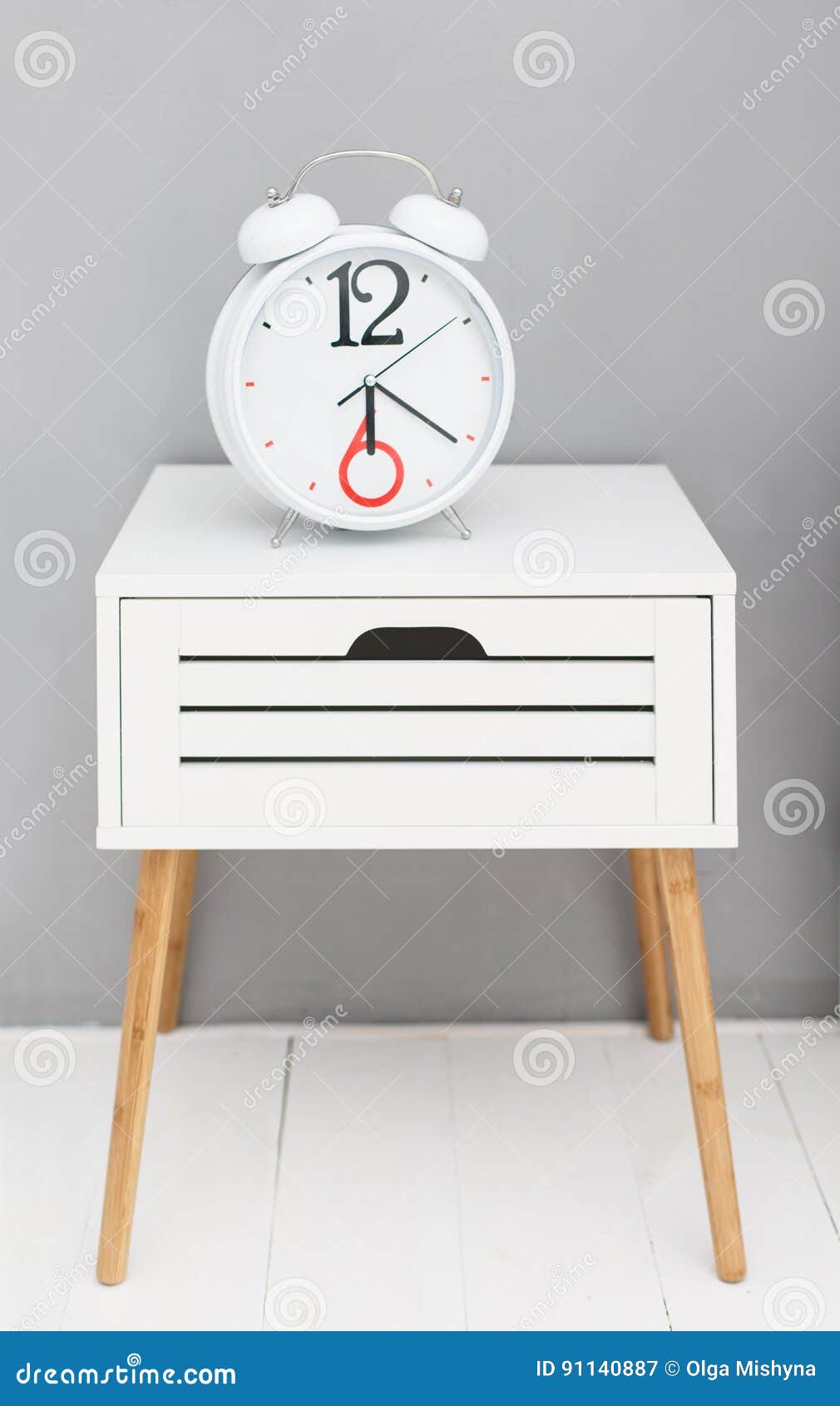 Clock on a White Nightstand Near Gray Wall Stock Image - Image of clock ...