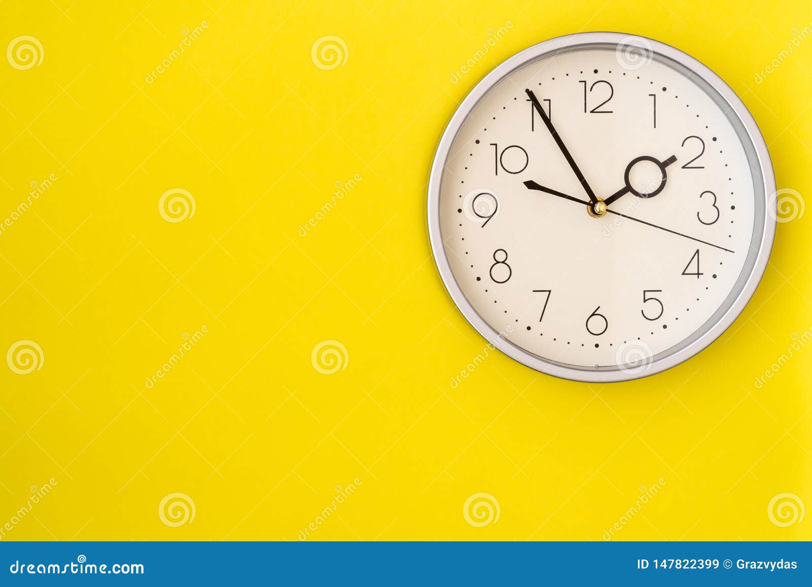 Clock on the yellow wall stock image. Image of time - 147822399