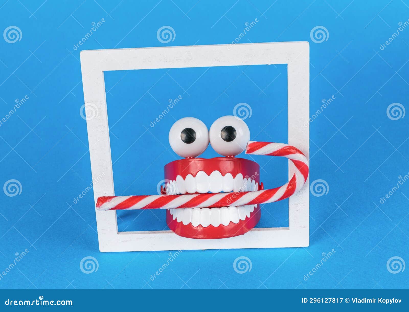 A Clockwork Toy with a Red and White Candy on a Blue Background Stock ...