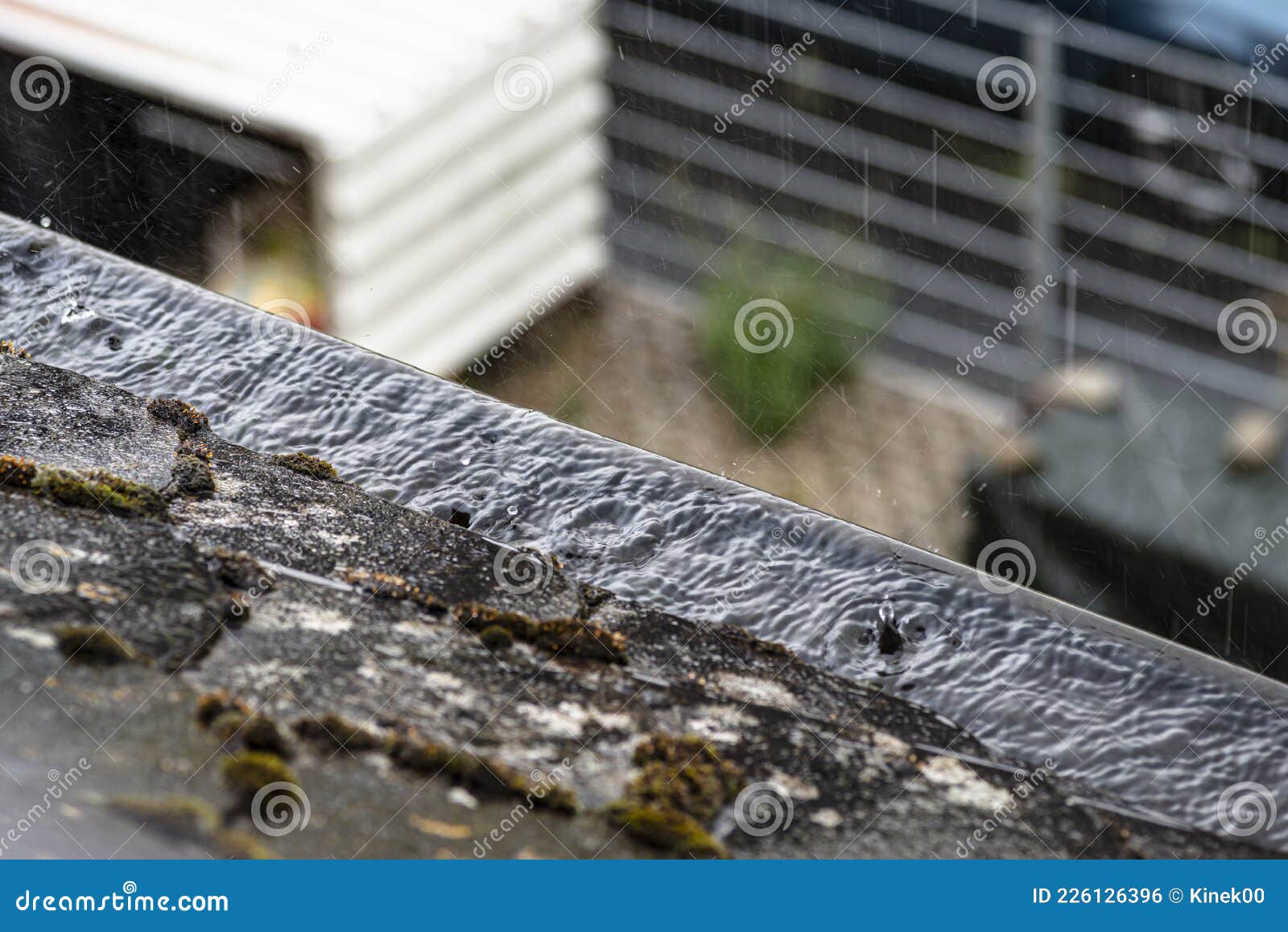 Clogged Gutter Filled with Water that Overflows in Rainy Weather. Stock ...