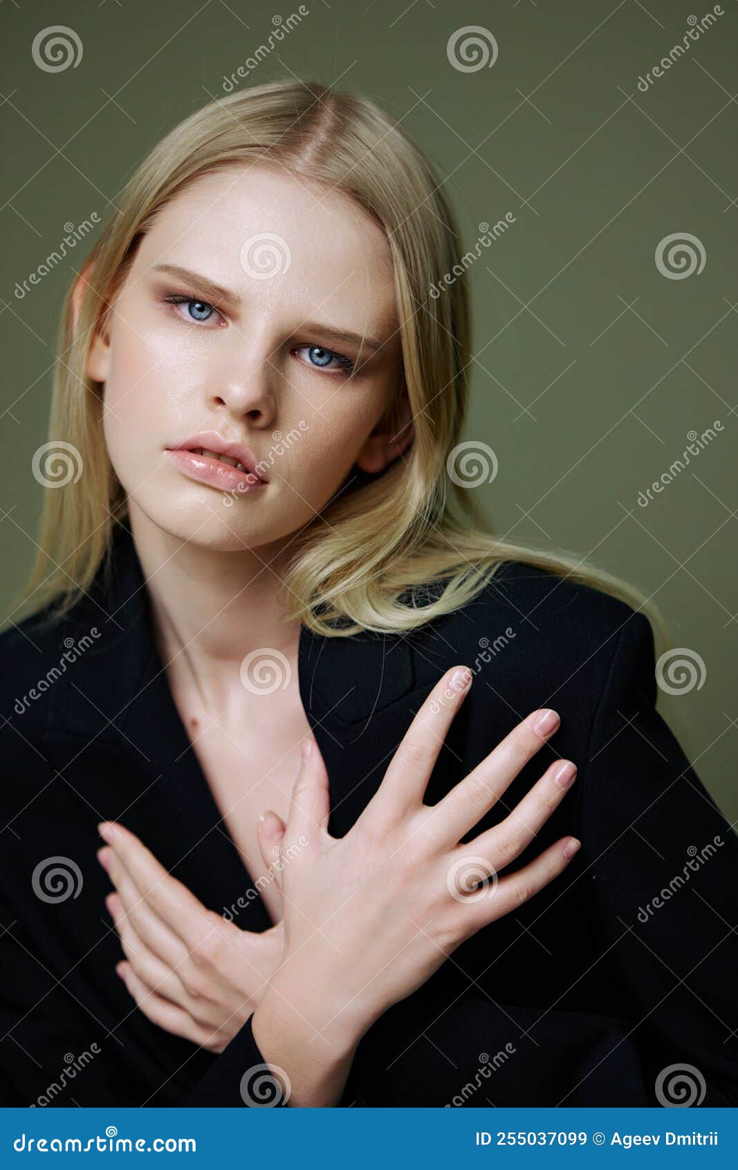 A Close Portrait Of A Blonde Crossing Her Arms On Her Chest Holding A