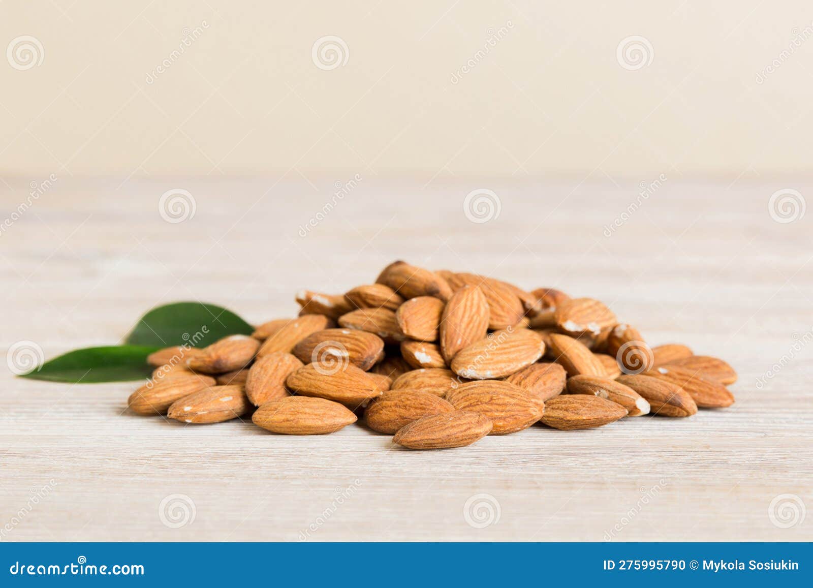 Close-up of Almonds Nuts with Leaves on Table Background. Top View ...