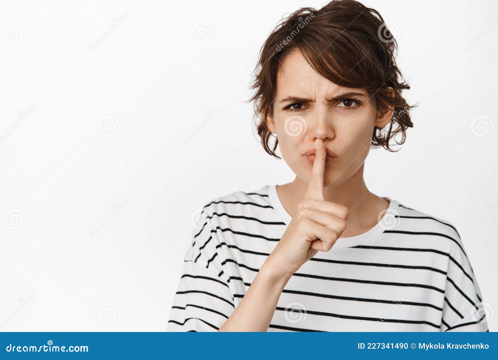 Close Up Of Angry Girl Hushing Frowning And Say Shh Press Finger To