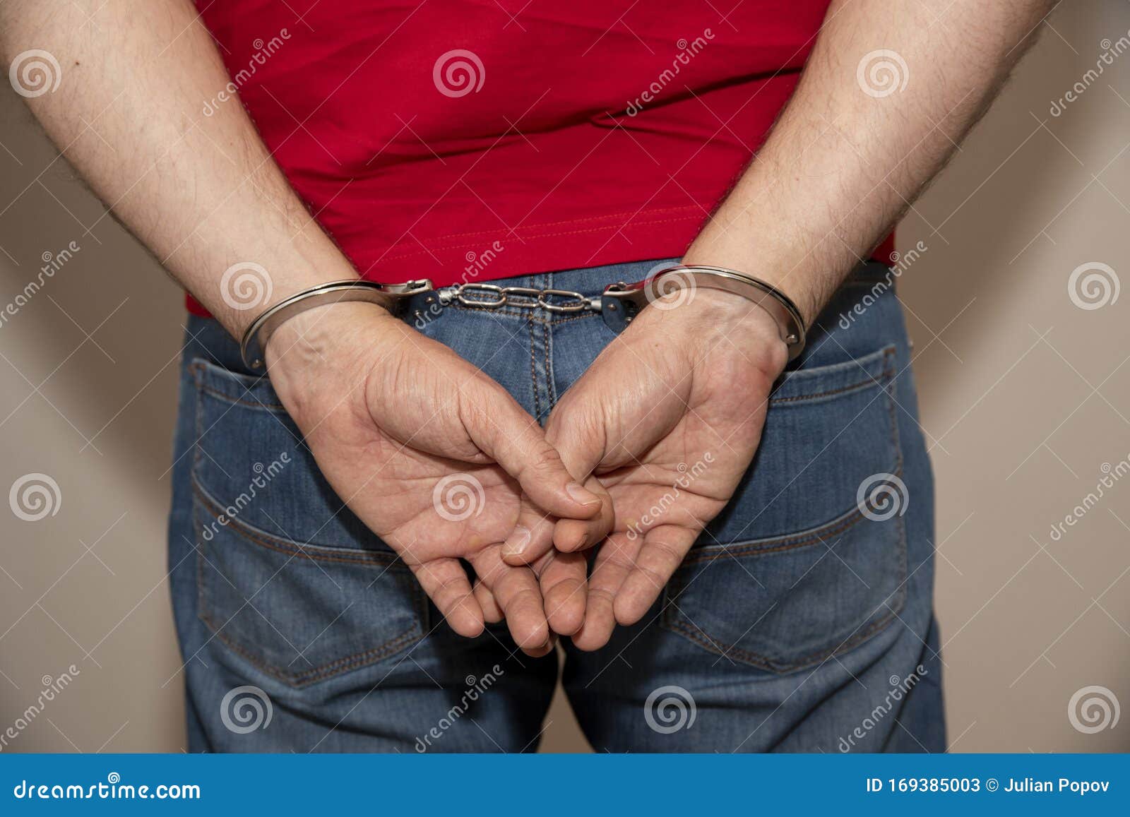 Close-up. Arrested Man Handcuffed Hands at the Back Isolated on Gray ...