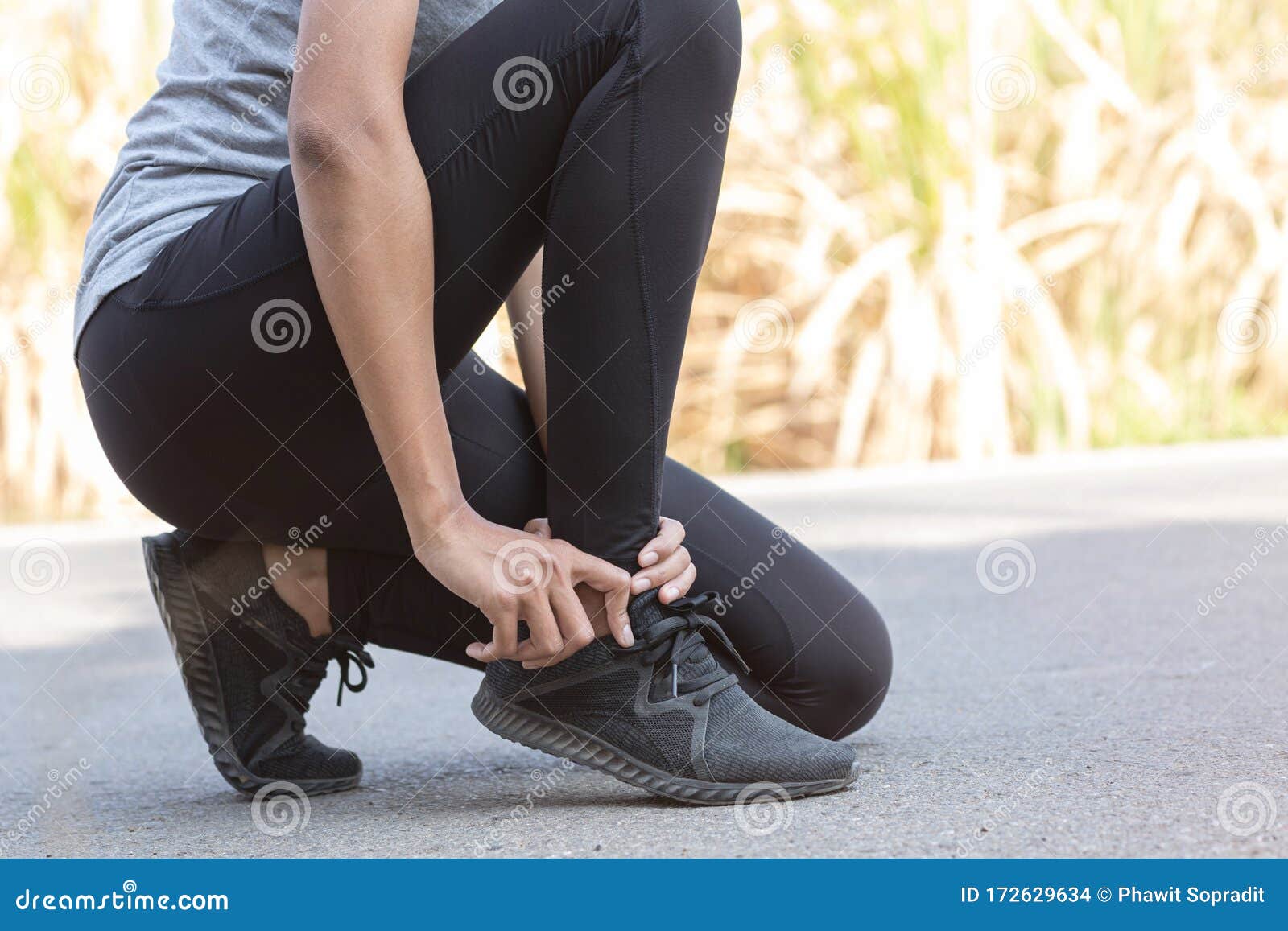 Close Up Athlete Running Woman Use Hands Hold on His Ankle while ... Close Up Athlete Running Woman Use Hands Hold on His Ankle while ...