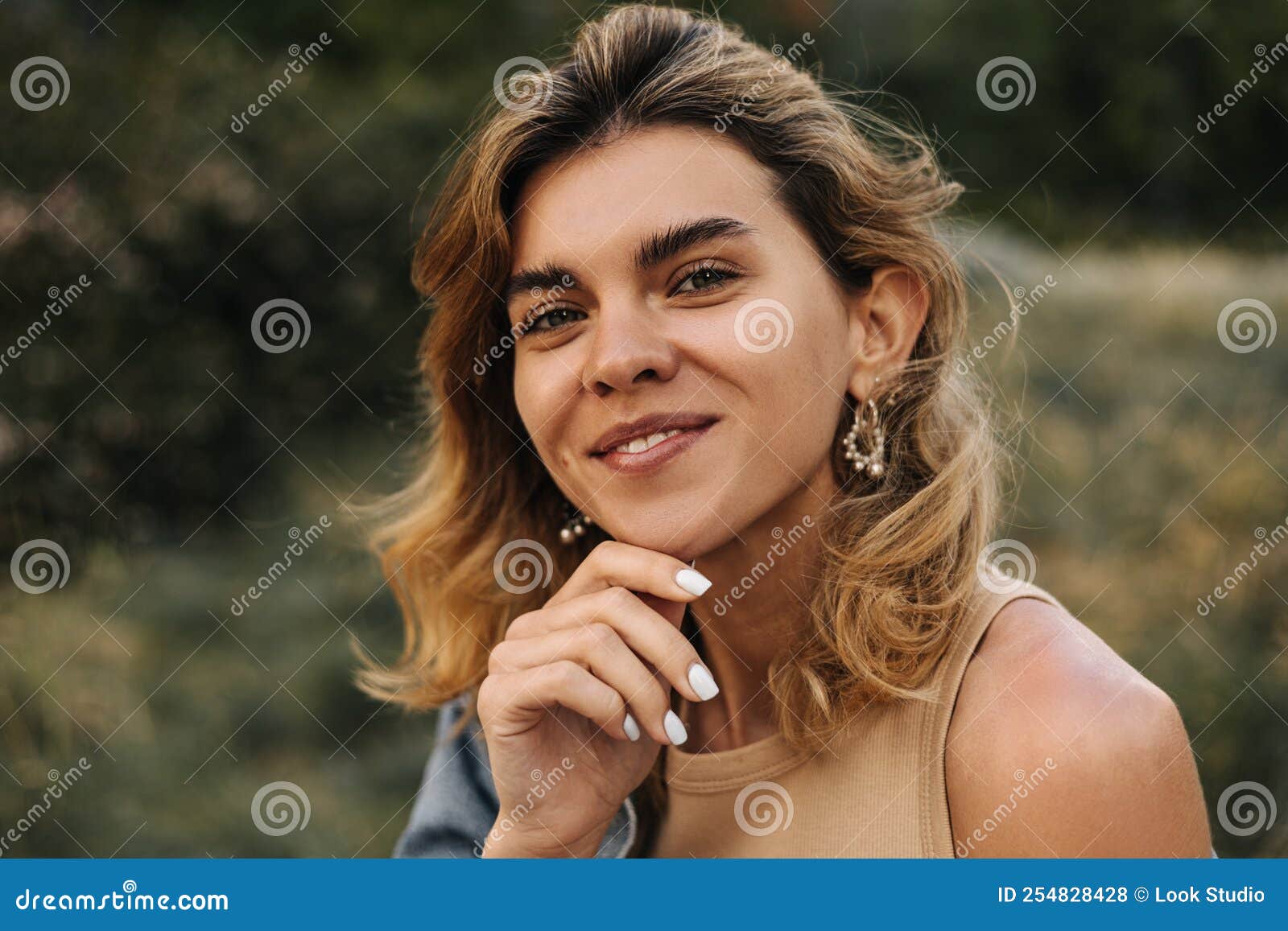 Close Up Of Attractive Young Caucasian Girl Looking At Camera Touching