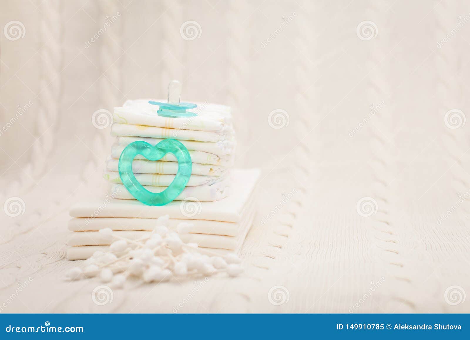 Close Up Baby Hygiene Items. Stack of Diapers, Ear Sticks, Baby Dummy ...