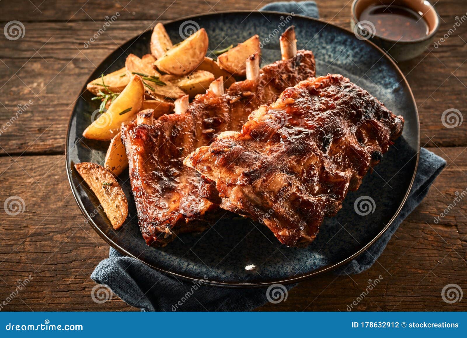 Close Up of Barbecued Ribs and Wedges on Timber Stock Photo - Image of ...