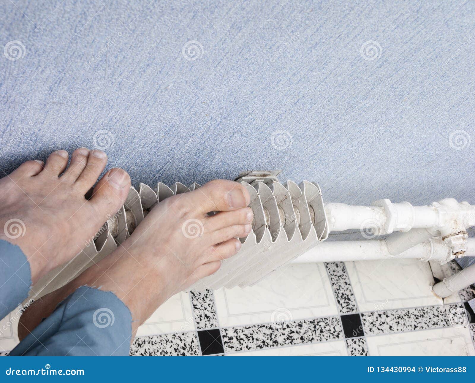 Bare feet on radiator stock photo. Image of freezing - 134430994