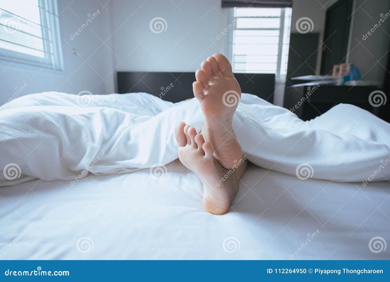 Close Up of Barefoot,Feet and Stretch Lazily on the Bed Stock Photo ...