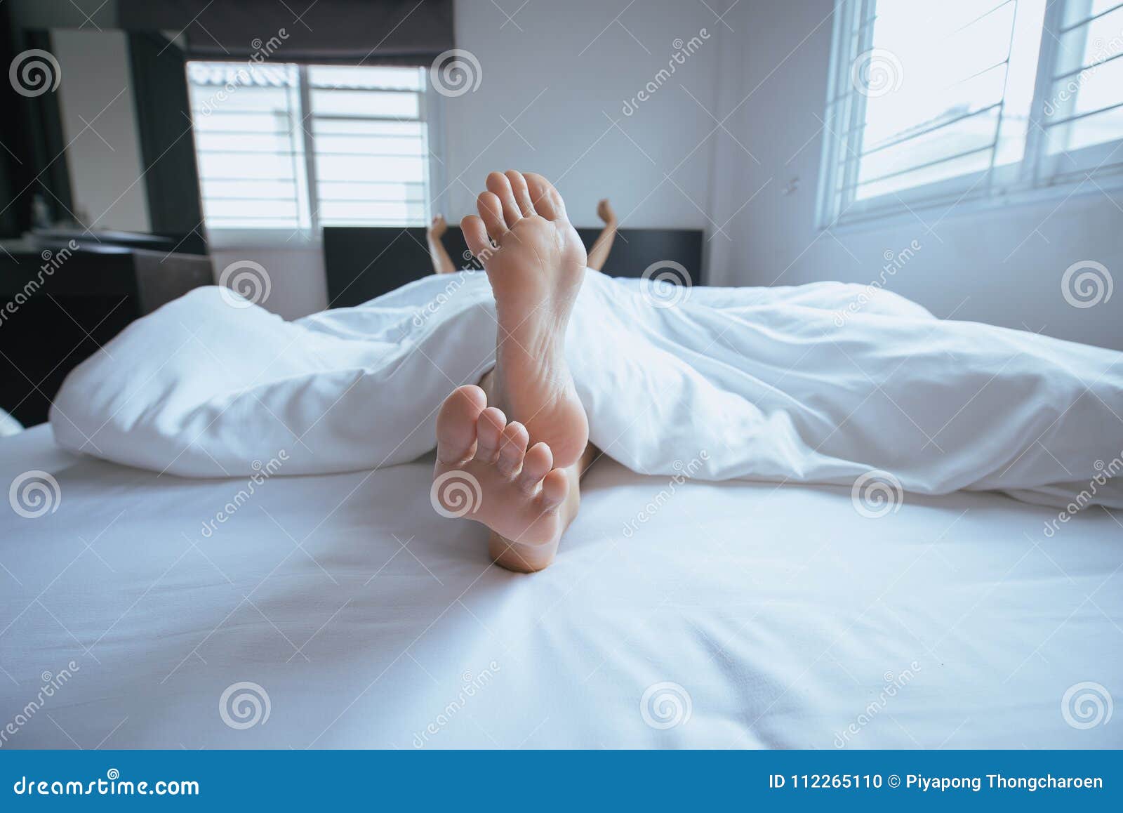 Close Up of Barefoot,Feet and Stretch Lazily on the Bed Stock Photo ...