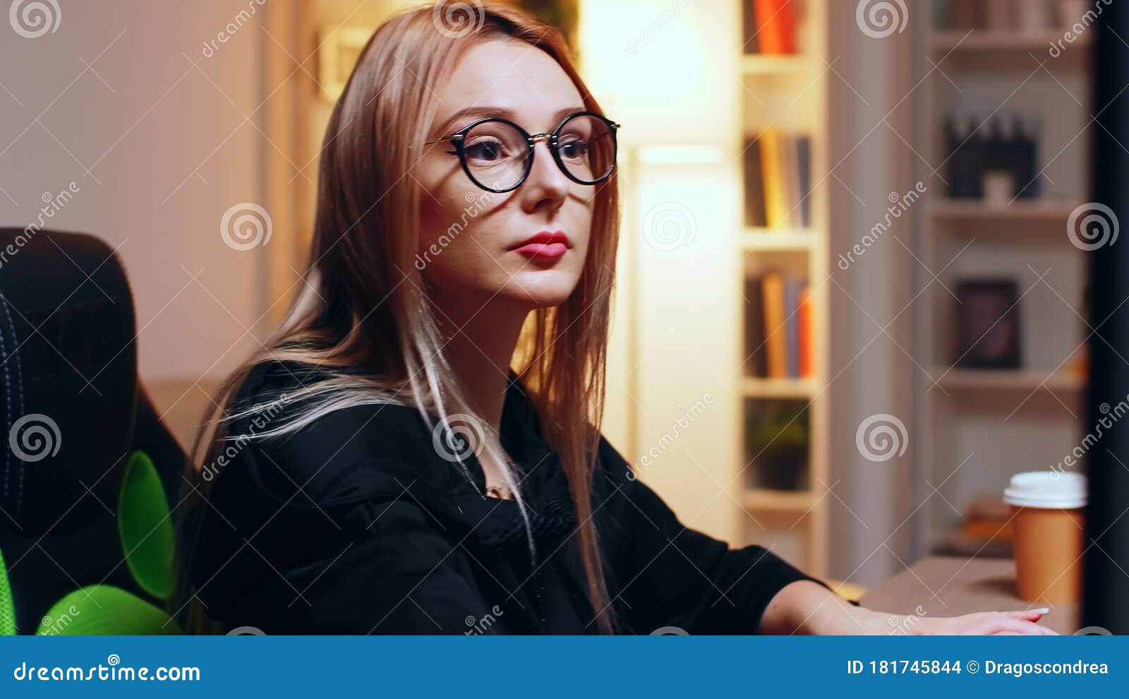 Girl Hacker In A Hood Typing Program Code While Committing A Cybercrime Hacking A System On The
