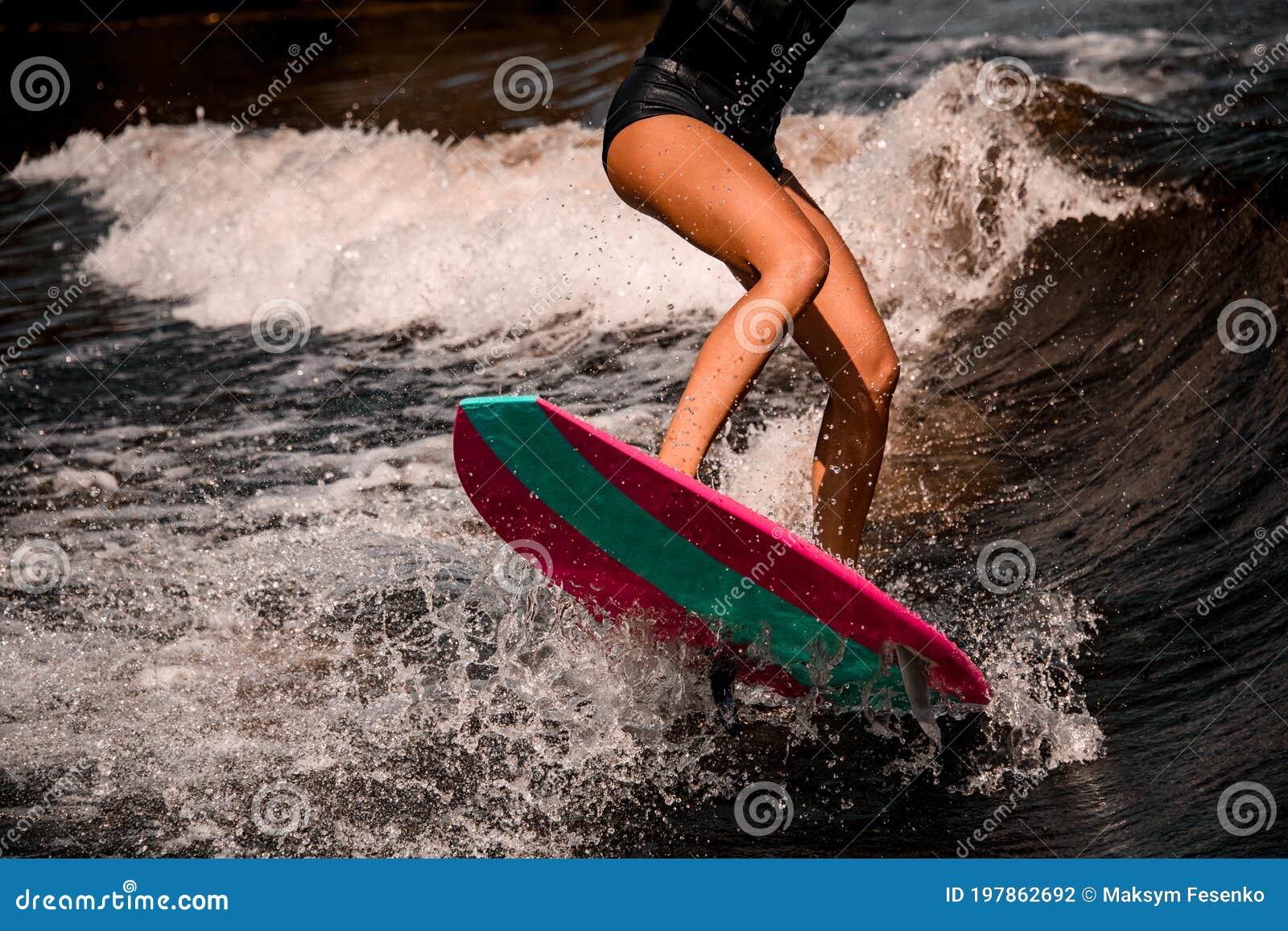 Close Up Of Beautiful Tanned Legs Of Woman Jumping On Wave On Surf