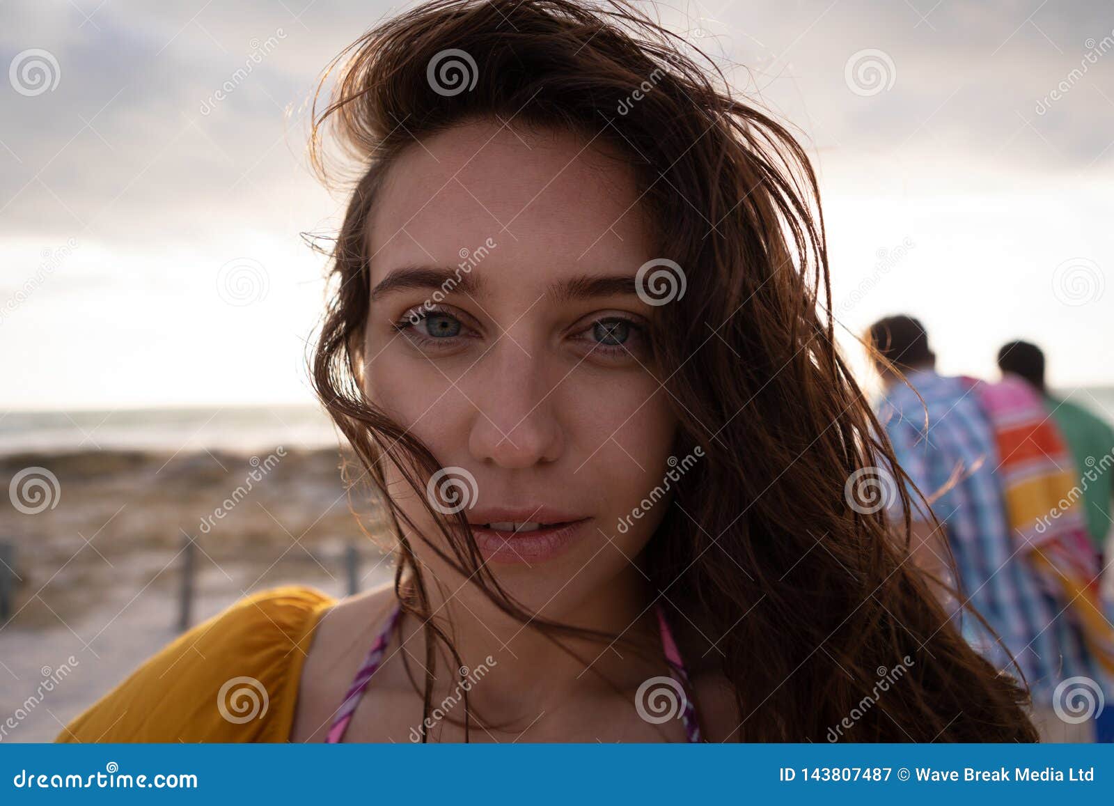 Close Up Of A Beautiful Woman Standing At Beach On A Sunny Day Stock