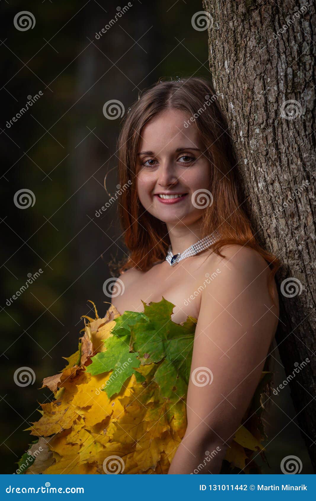 Close Up On Beautiful Young Girl With Long Hair Leaning On Tree