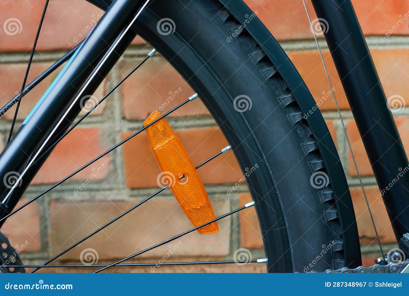 Close-up of a Bicycle Wheel with an Orange Plastic Reflector Mounted on ...