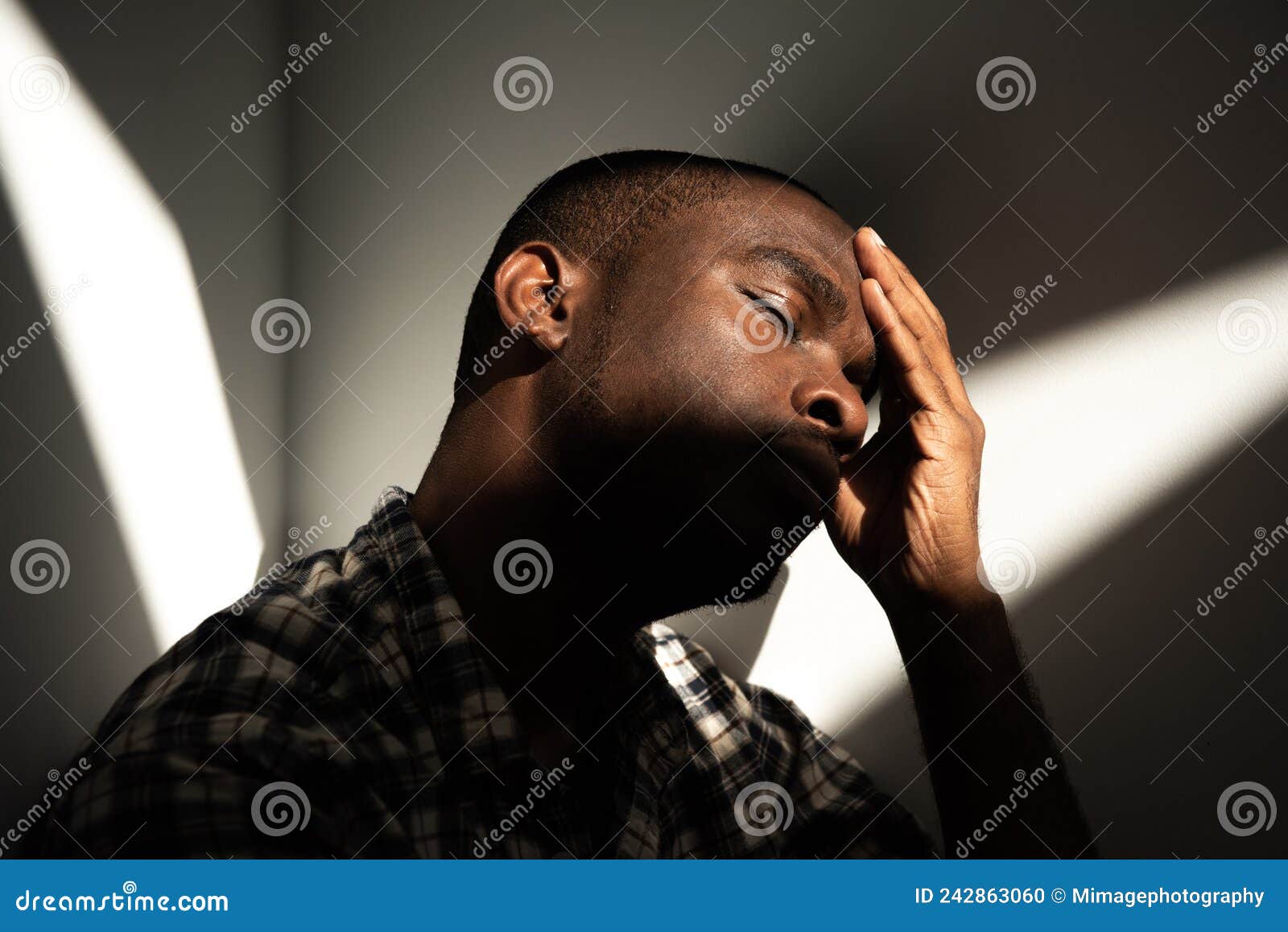 Close Up Black Man Sleeping in Shadow with Hand on Head Stock Photo ...