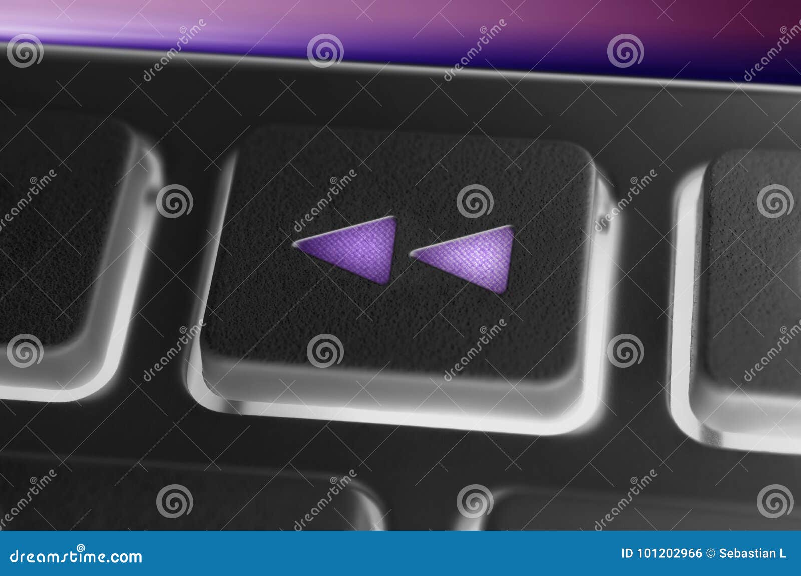 Close Up of a Black Rewind Button of a Black Remote Control with ...