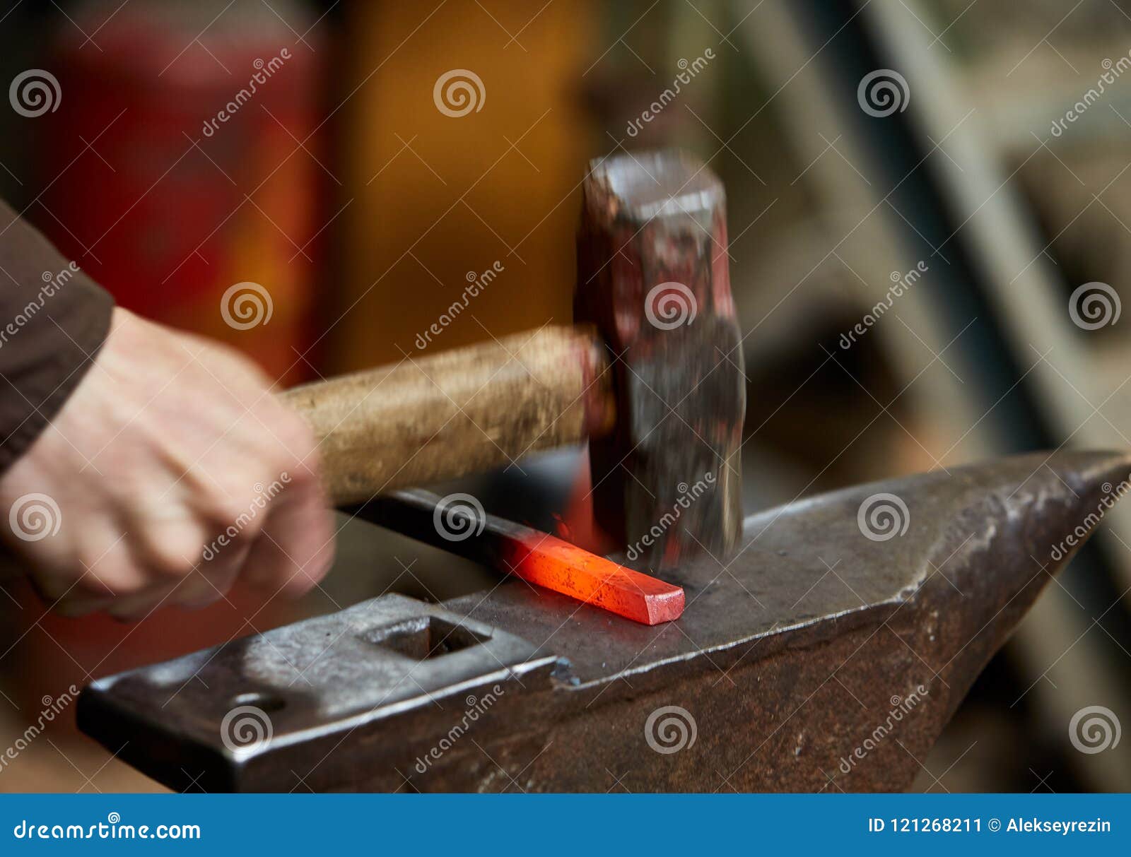 Close-up of a Blacksmith`s Hands Manipulating a Metal Piece Above His ...