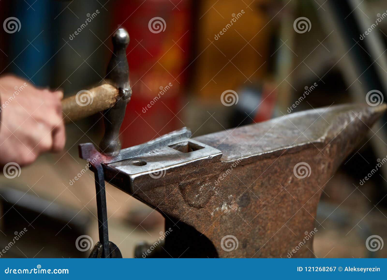 Close-up of a Blacksmith`s Hands Manipulating a Metal Piece Above His ...