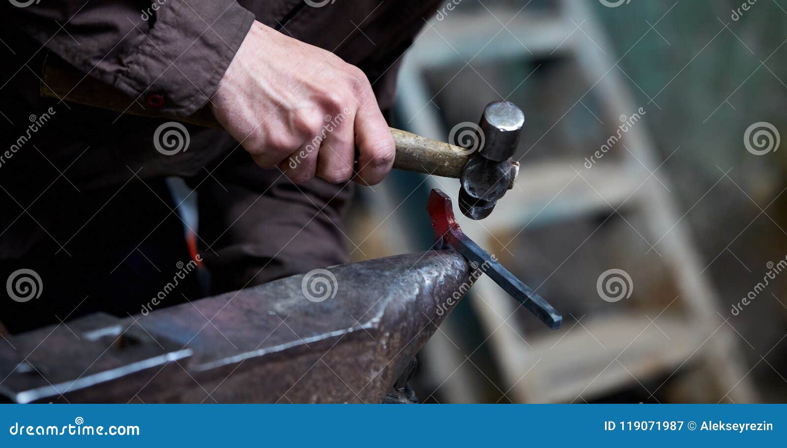 Close-up of a Blacksmith`s Hands Manipulating a Metal Piece Above His ...