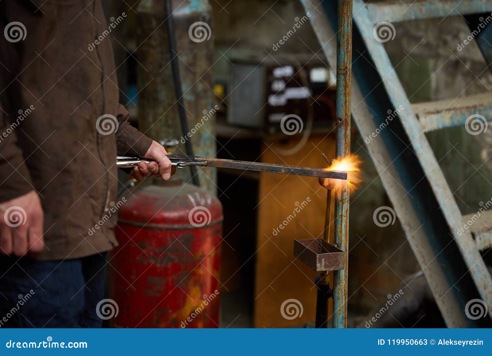 Close-up of a Blacksmith`s Hands Manipulating a Metal Piece Above His ...