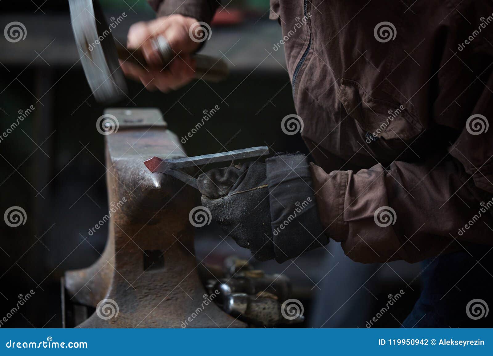 Close-up of a Blacksmith`s Hands Manipulating a Metal Piece Above His ...