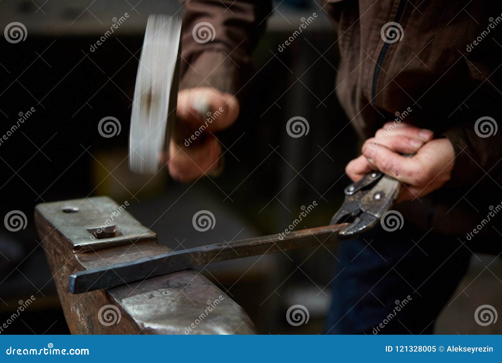 Close-up of a Blacksmith`s Hands Manipulating a Metal Piece Above His ...