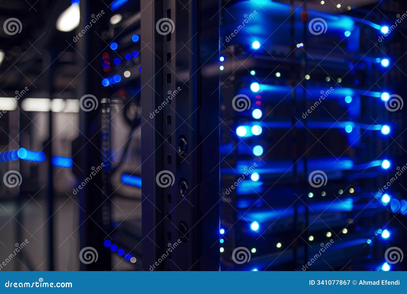 Close-up of Blue-lit Server in a Blurred Data Center Background ...