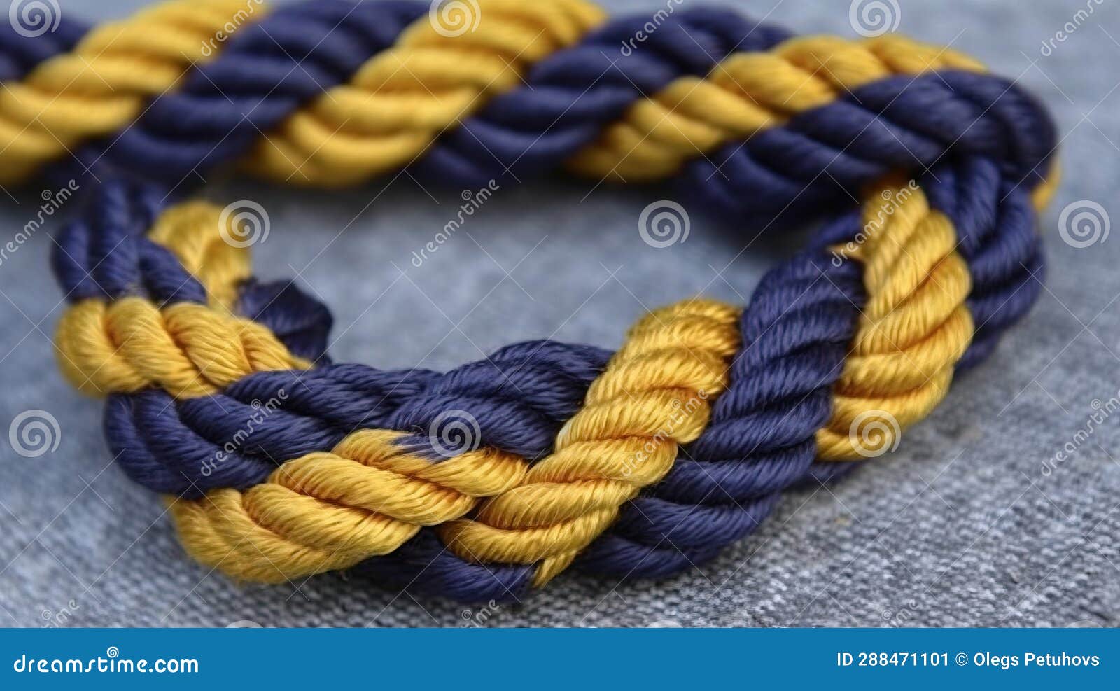 A Close Up of a Blue and Yellow Rope on a Gray Surface Stock ...