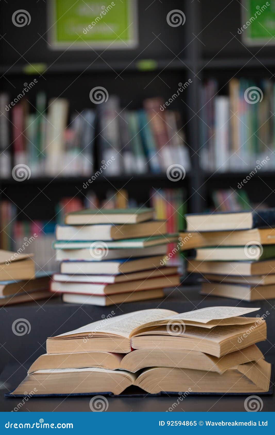 Close Up of Books Stack on Table Against Shelf Stock Image - Image of ...