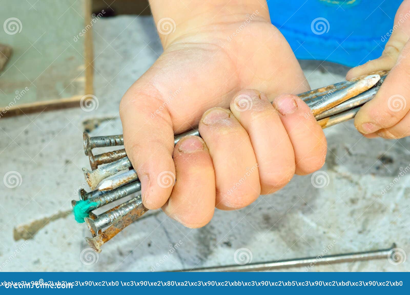 Boy Holds Large Iron Nails in His Hand Stock Photo - Image of work ...