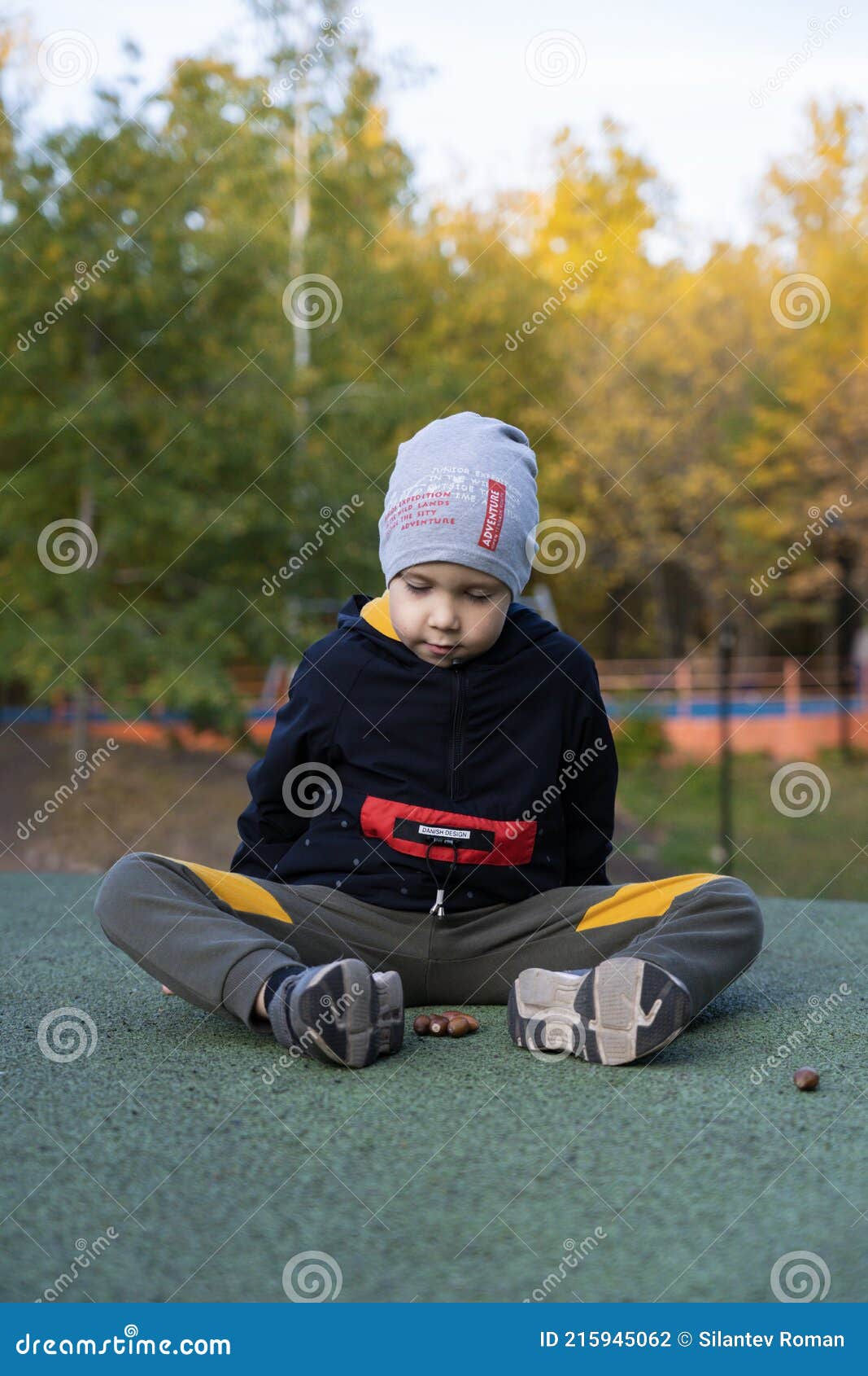 Close-up of a Boy Sitting on the Playground and Playing Stock Photo ...