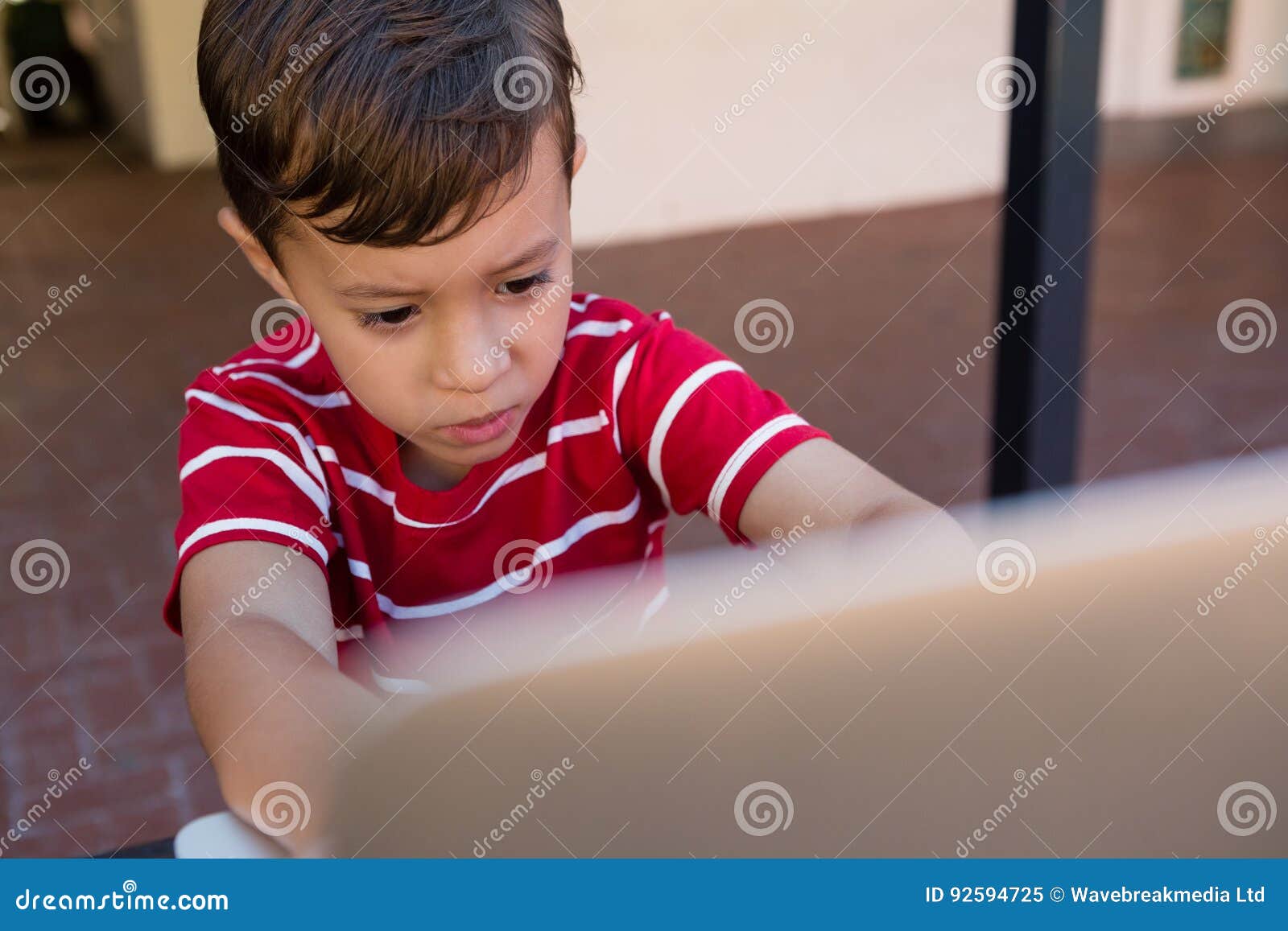 Close Up of Boy Using Laptop Computer while Sitting on Chair Stock ...