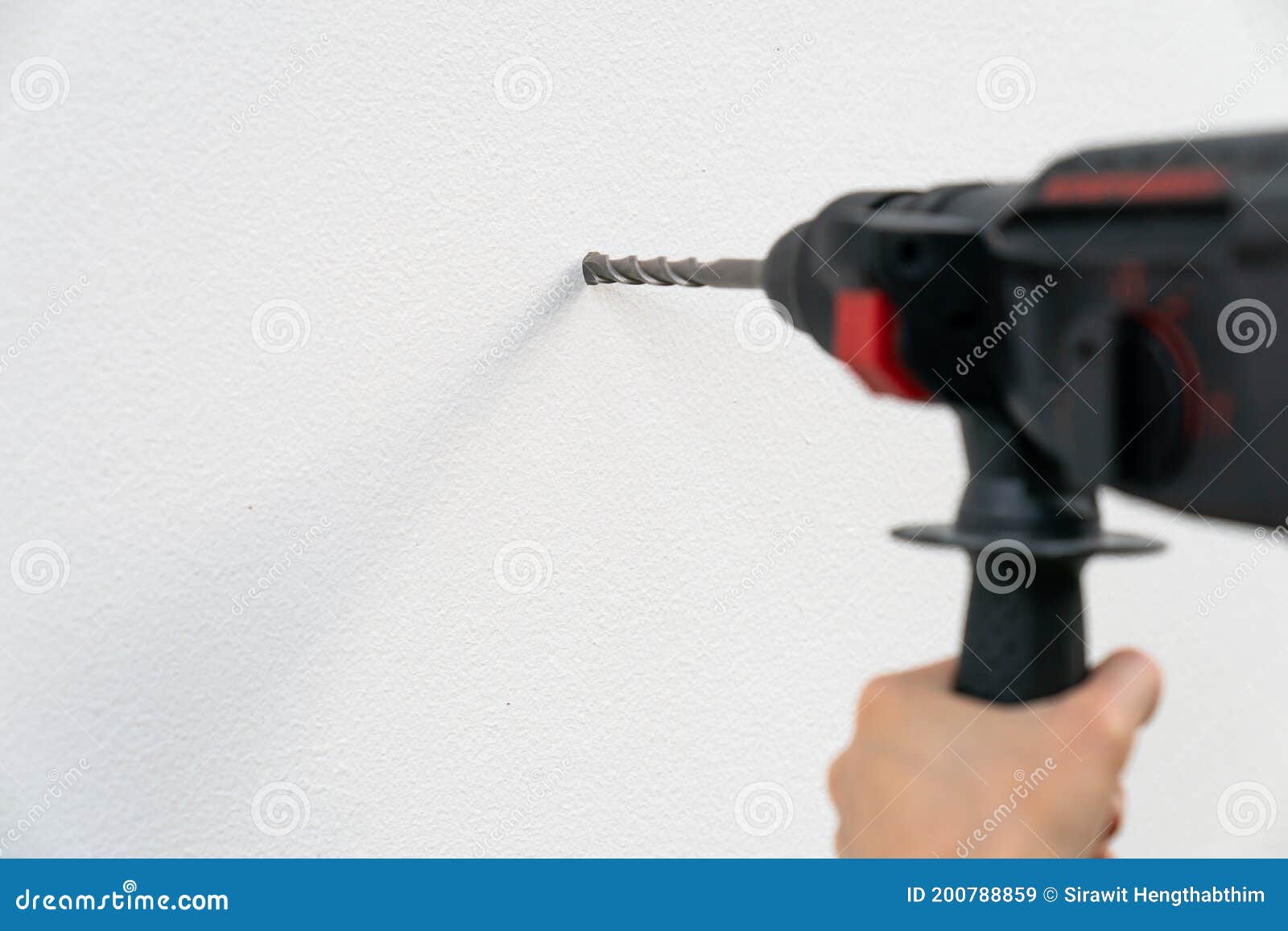 Close Up Builder or Worker Hand Drilling with a Machine on White Wall ...
