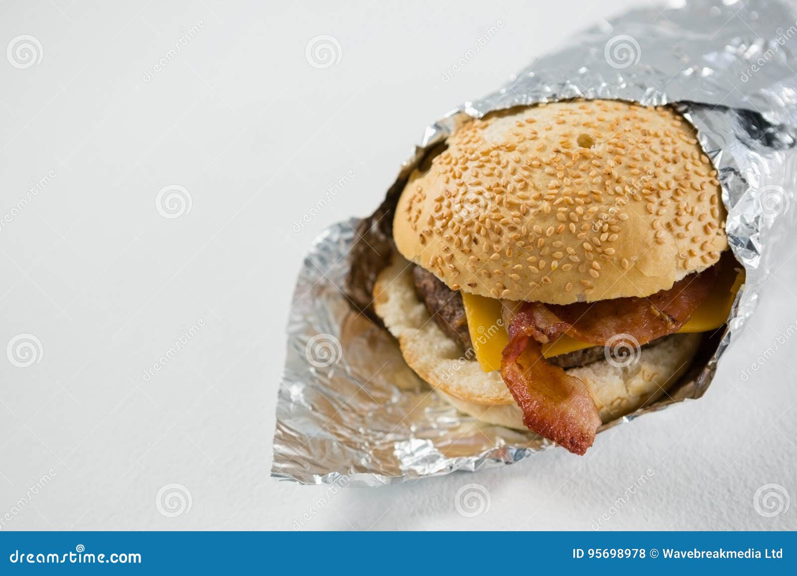 Close Up of Burger Wrapped in Foil Paper Stock Photo - Image of meat ...