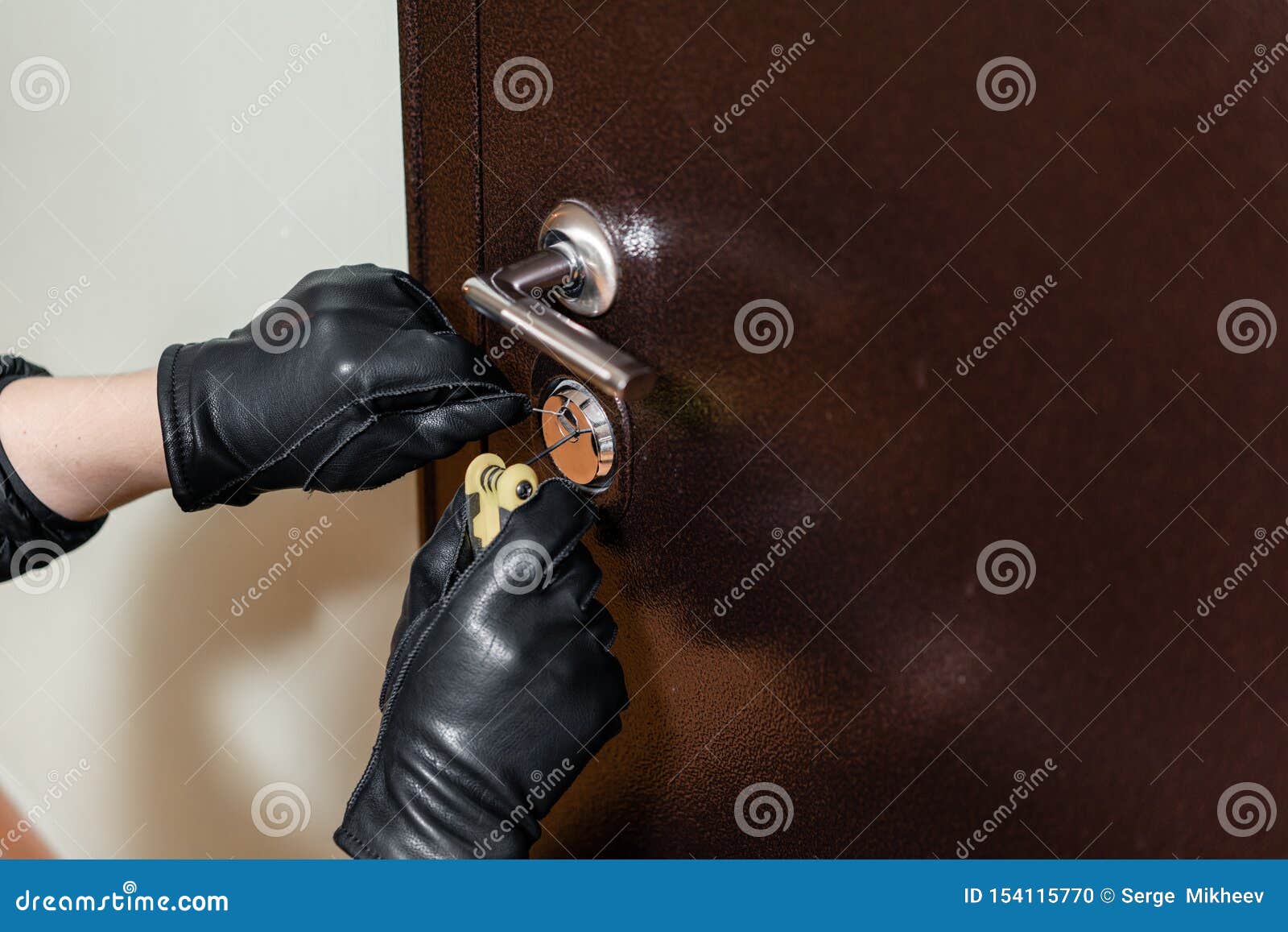 Close Up of a Burglar with Gloves Picking a Lock. Thief with a Passkey ...