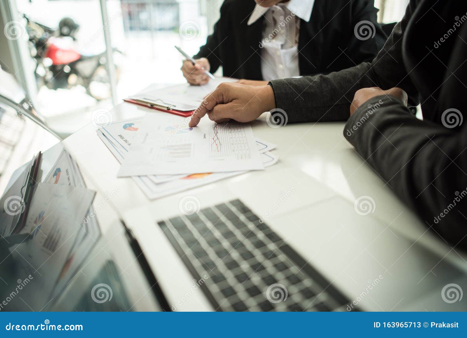 Close Up of Business People Working with Business Document during ...