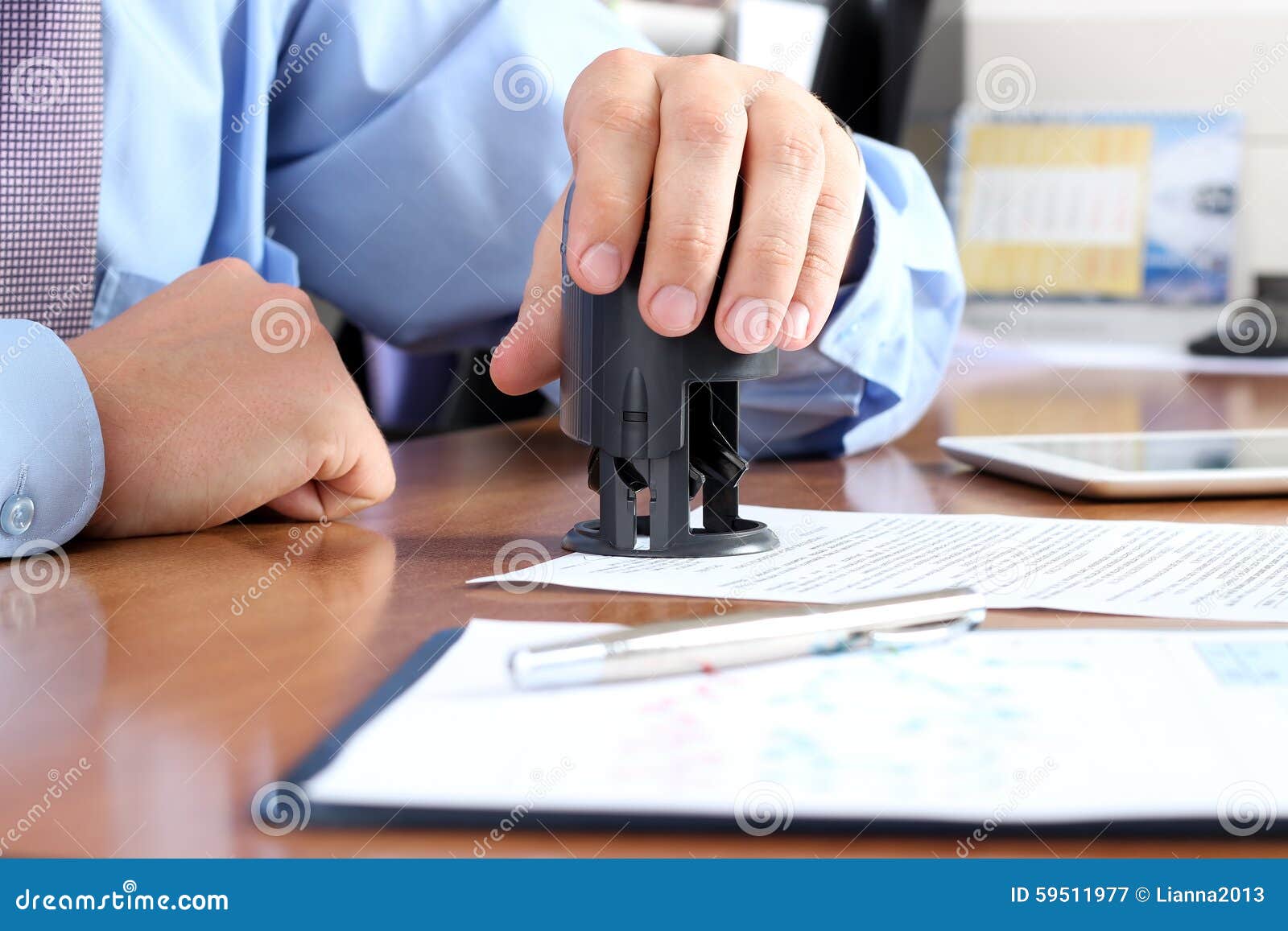Close-up of Businessman Hand Pressing a Stamp on Document in the Office ...