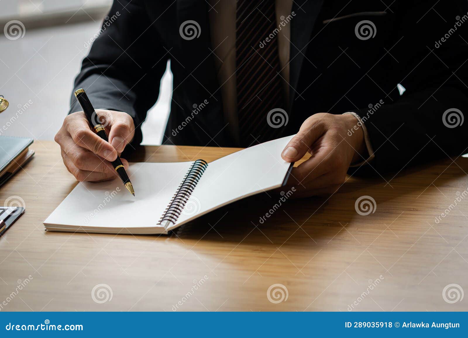 Close-up of Businessman S Hands Writing Something Down in a Notebook ...