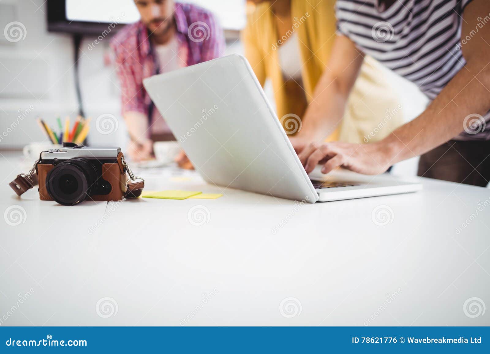Close-up of Camera on Desk with Professionals Working at Office Stock ...