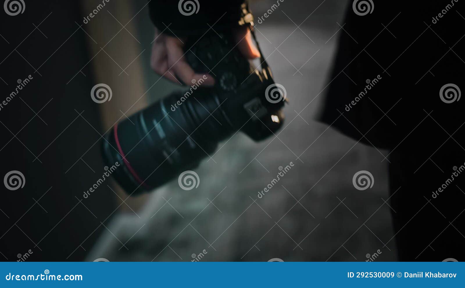 Close-up of a Camera in the Hand of a Man Walking Down a Corridor. the ...