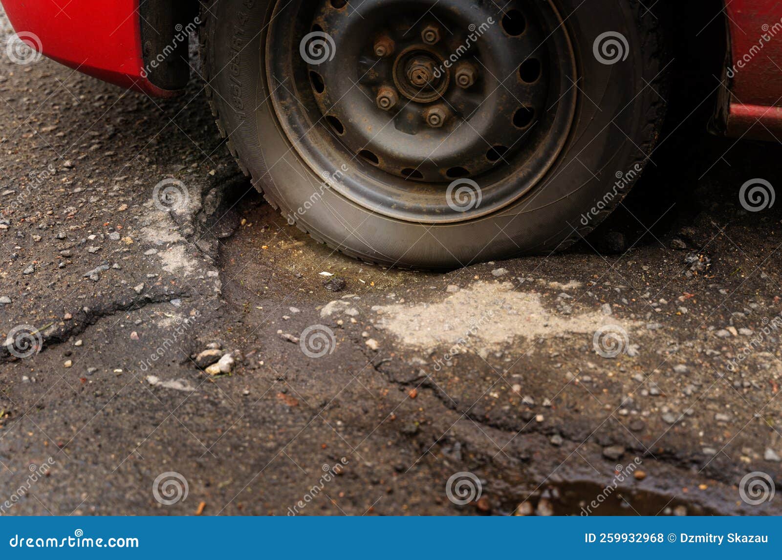 A Close-up of a Car Wheel Stuck in a Pothole in the Asphalt. Stock ...