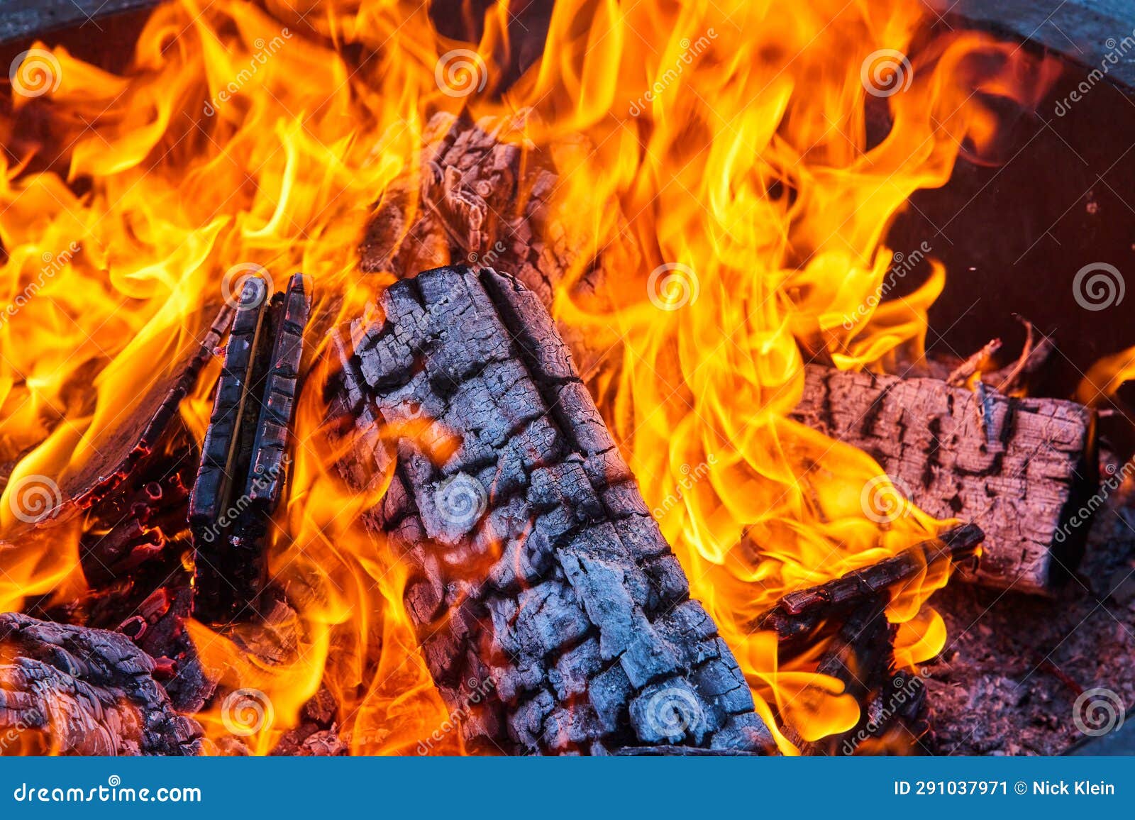 Close Up of Charred and Burning Logs Inside Intense Fire with Orange ...
