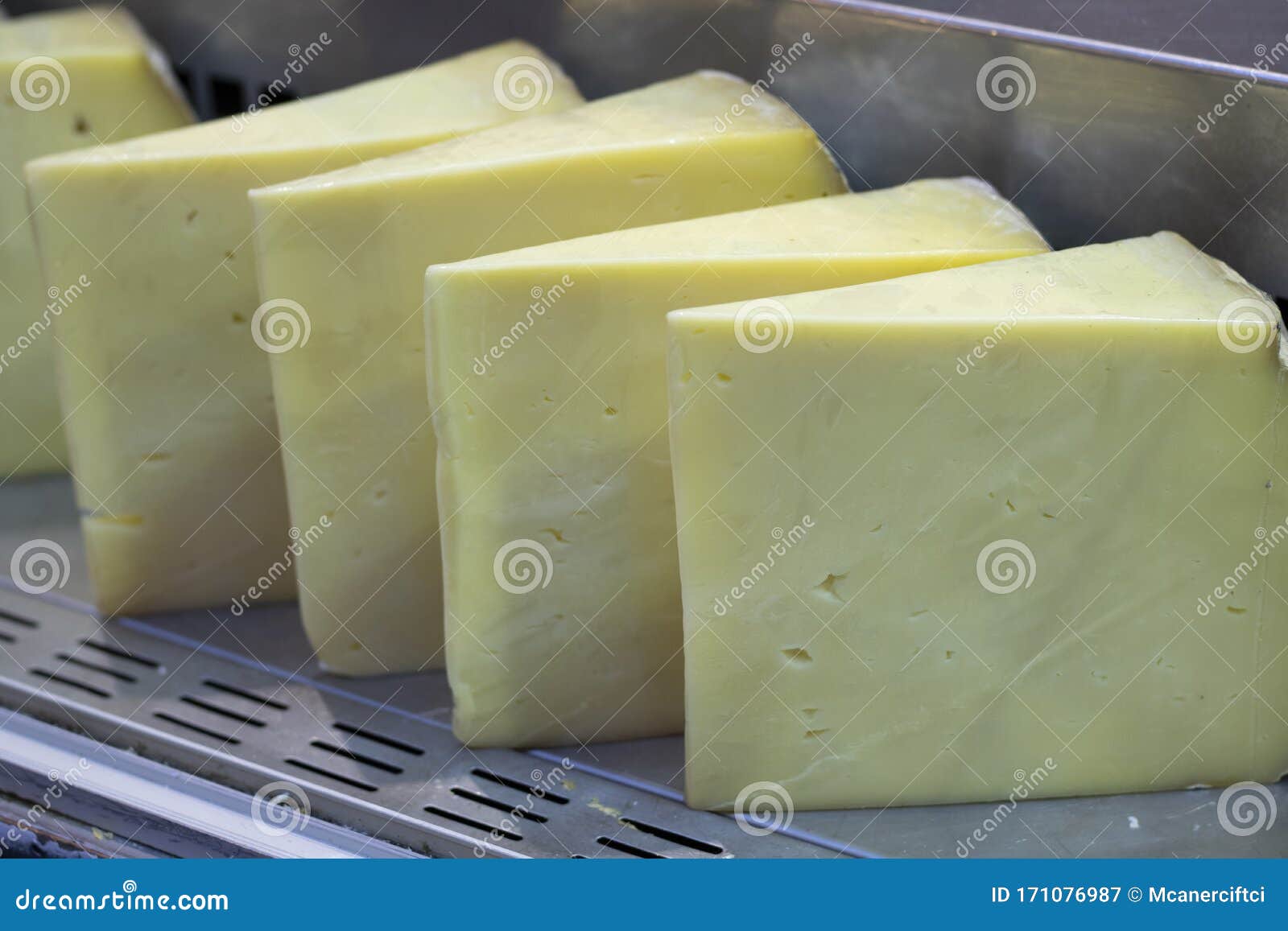 Close-up of Cheddar Cheese is Sold in the Market. Triangular Slice ...