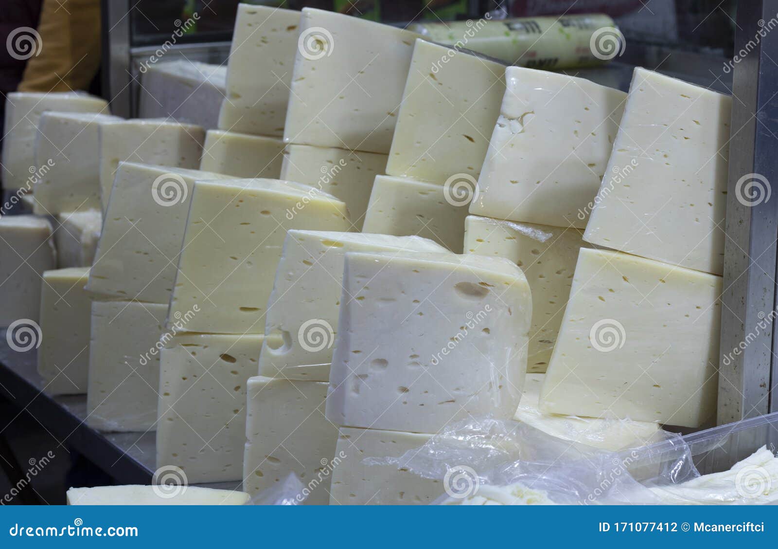 Close-up of Cheddar Cheese is Sold in the Market. Triangular Slice ...