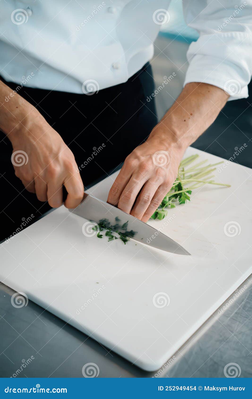 Close-up of a Chef Finely Chopping Herbs in a Professional Kitchen ...