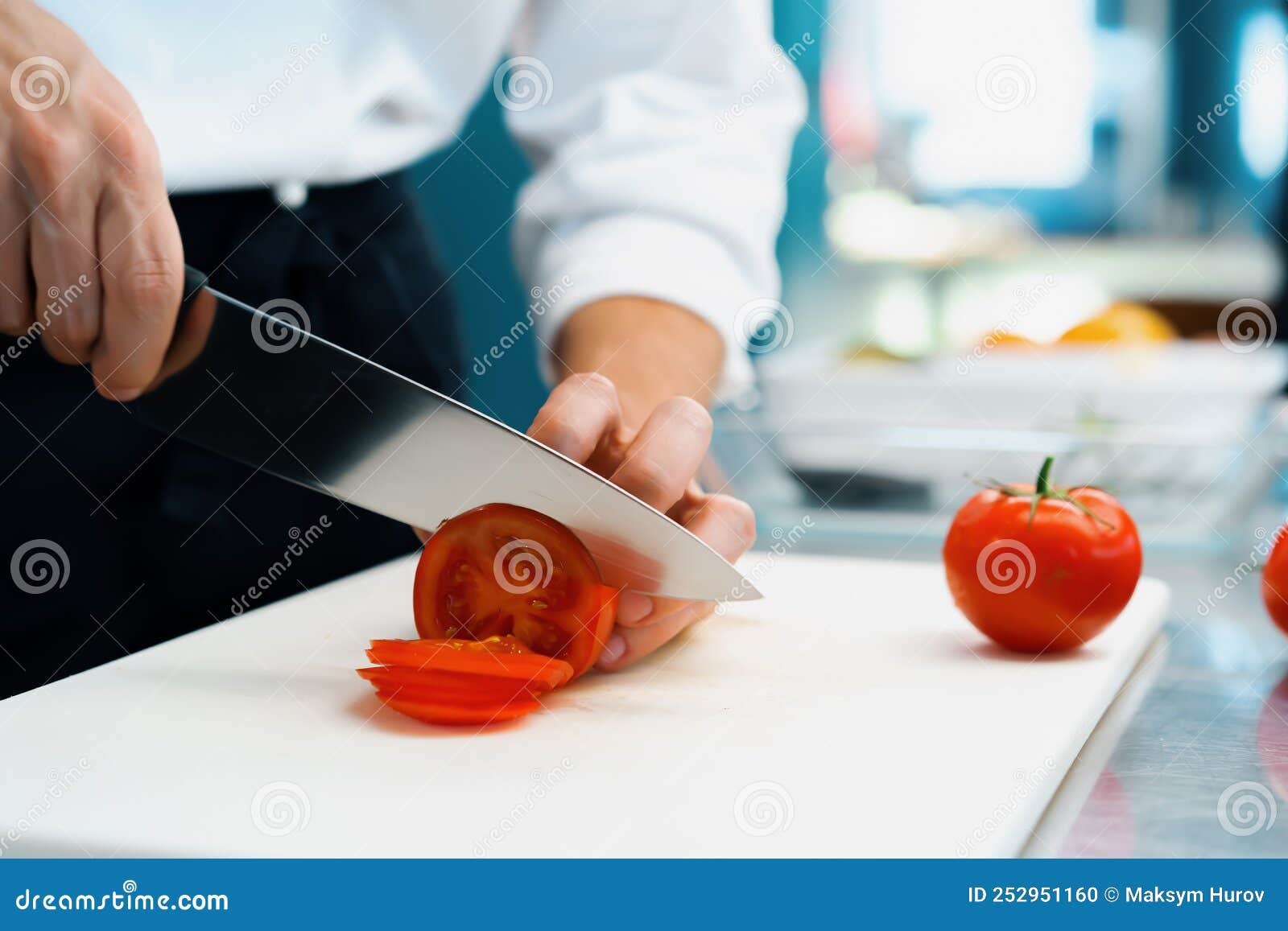 Close-up of a Chef Slicing Tomato in a Professional Restaurant Kitchen ...