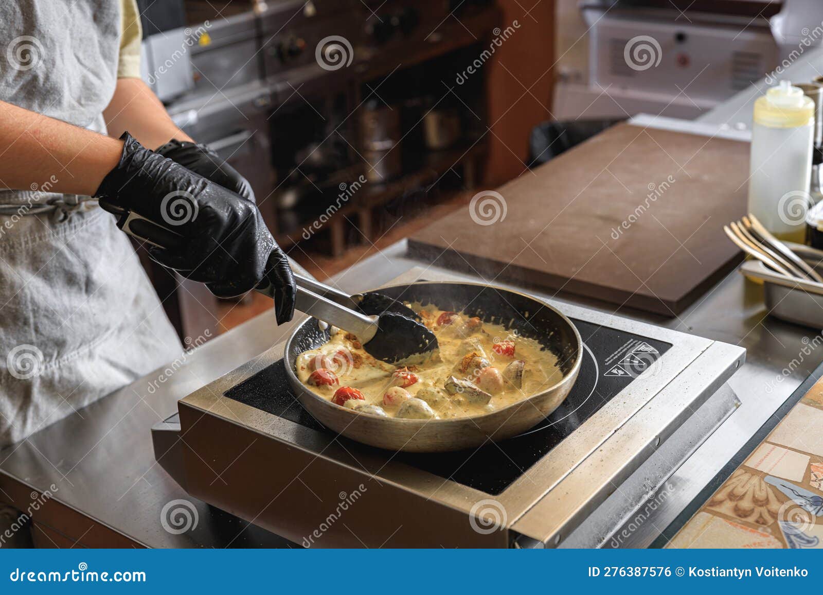 Close Up of Chef in Uniform is Cooking Dish on Frying Pan for Client ...