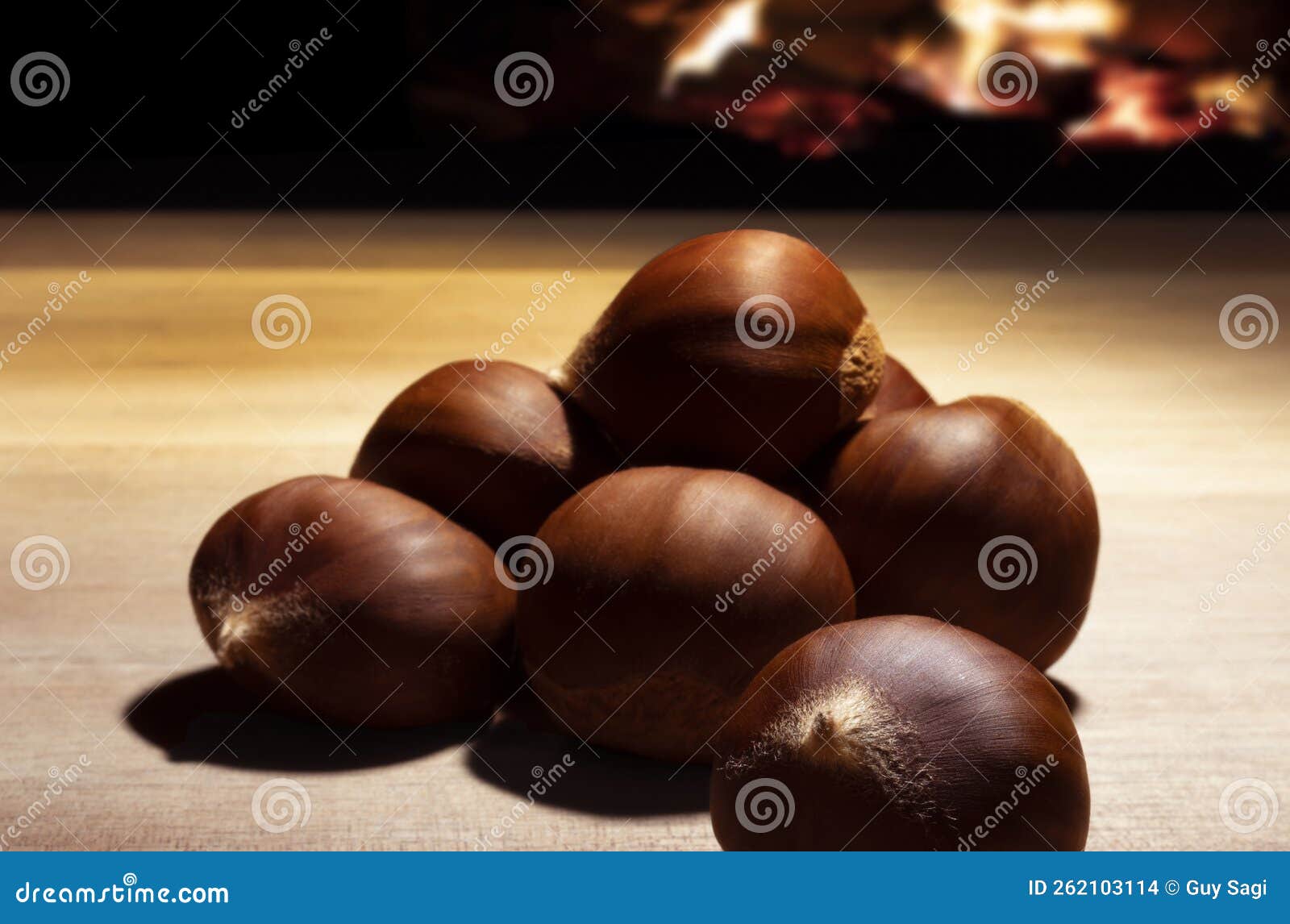 Close Up of Chestnuts Ready To Roast with Fire Behind Stock Photo ...